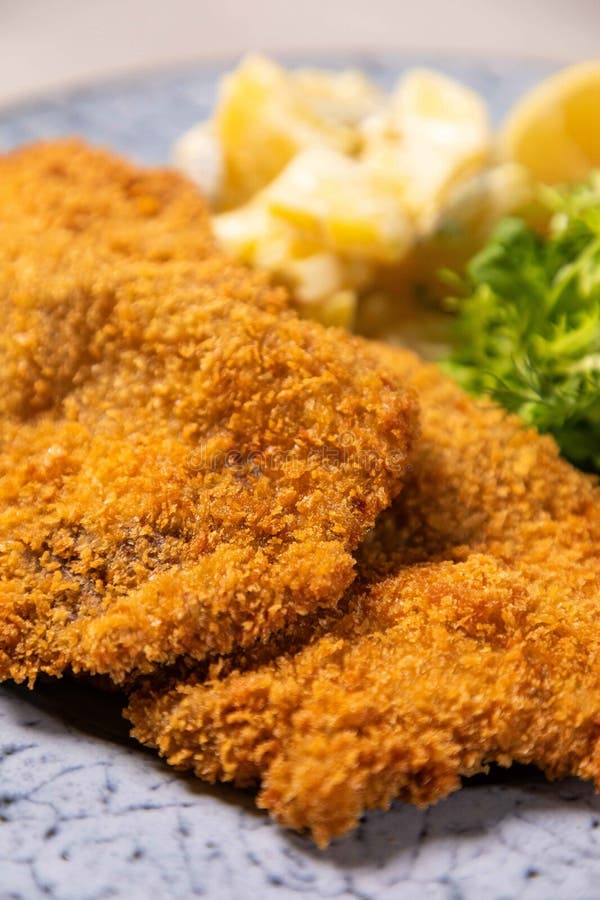 Breaded Chicken Schnitzel is Served on Plate with Potatoes Salad and ...