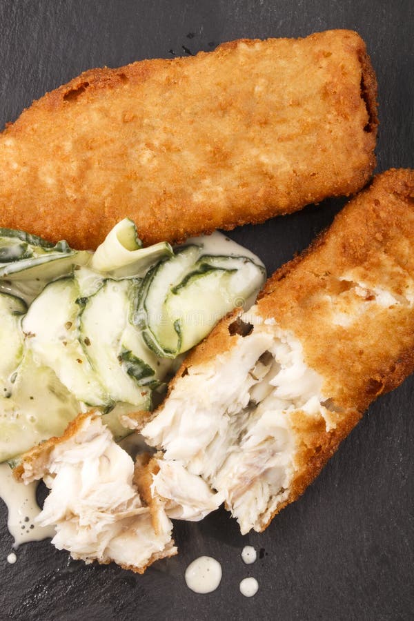 Breaded Cod and Fresh Cucumber Salad on Slate Stock Photo - Image of ...