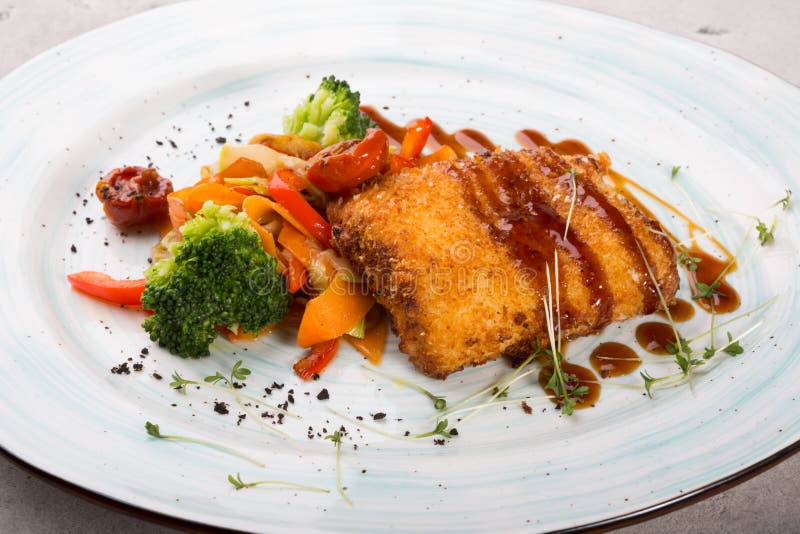 Breaded Fish Cutlet Served with Grilled Vegetables Stock Photo - Image ...