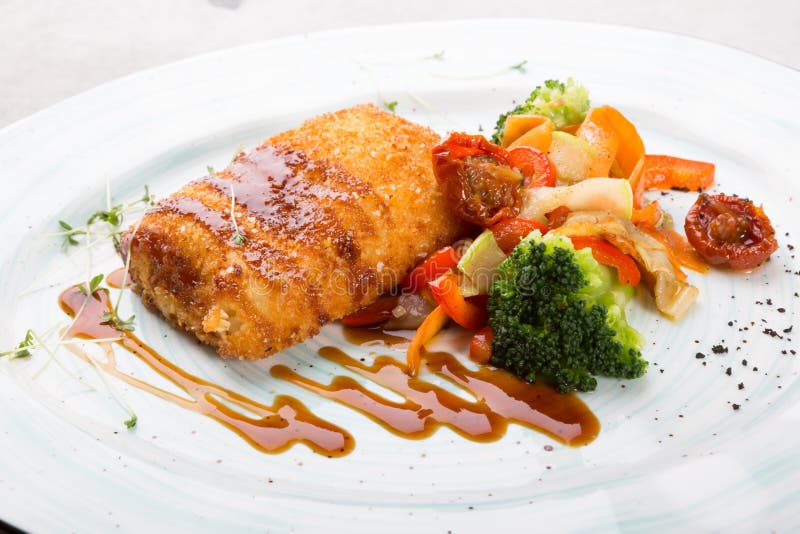 Breaded Fish Cutlet Served with Grilled Vegetables Stock Image - Image ...