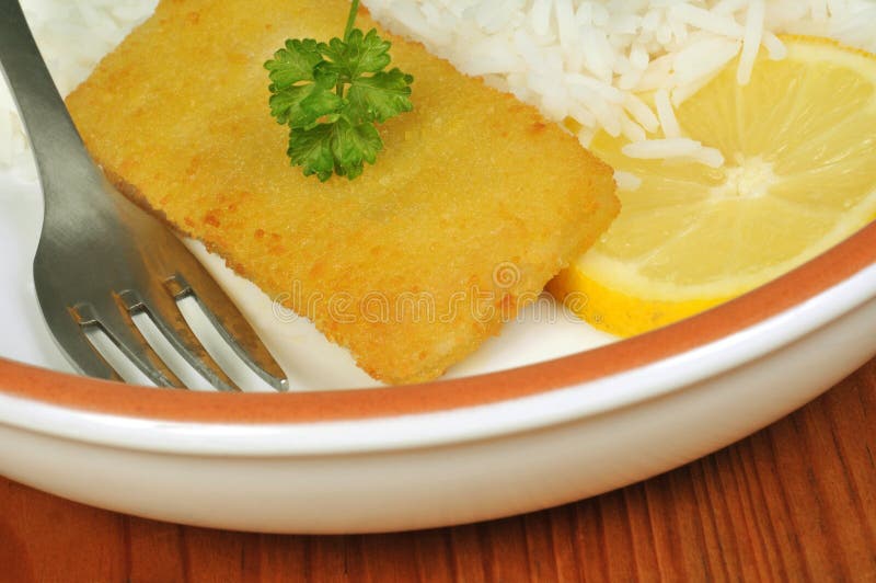 Breaded Fish with Rice and a Slice of Lemon Stock Photo - Image of meal ...