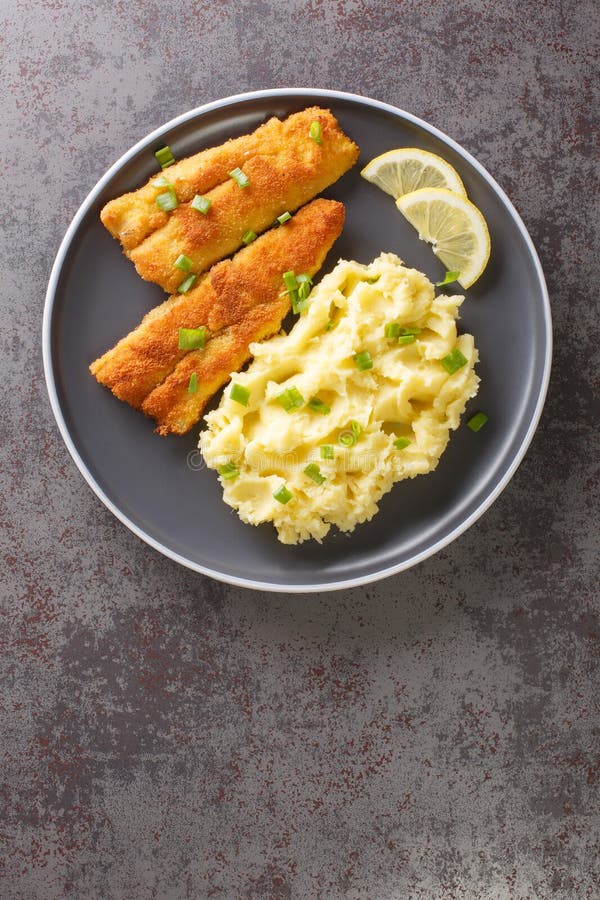 Breaded Fish with a Side Dish of Mashed Potatoes and Lemon Close-up in ...