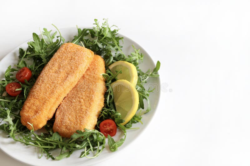 Breaded and Fried Fish Fillets with Salad and Lemon. Stock Photo ...