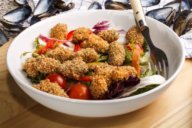 Breaded Mussels with Fresh Salad in a Deep Dish Stock Image - Image of ...