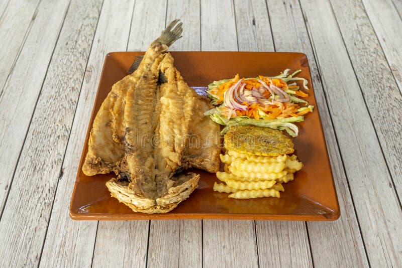 A Breaded Sea Bass Split in Half with a Side of Salad Stock Image ...