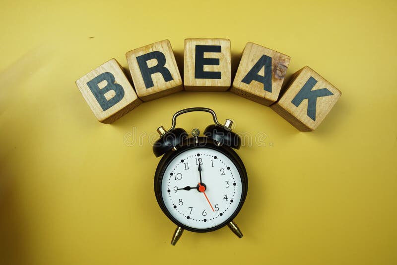 Break Word and Alarm Clock Top View on Yellow Background Stock Photo ...