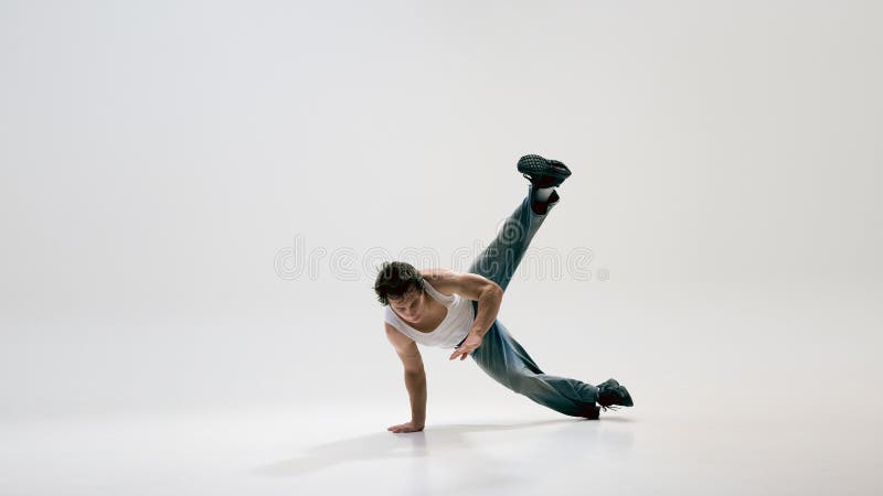 Young Breakdancer Balancing on One Hand Against White Background. Ffull ...