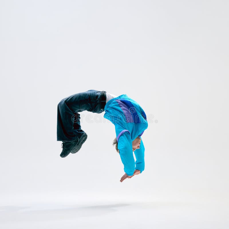 Breakdancer Leaping Mid-air, Back Arched, Against White Background ...