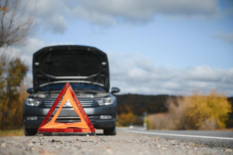 Breakdown Triangle Stands Near a Broken Car. Stock Image - Image of ...