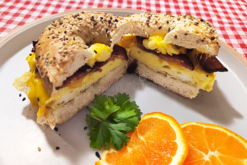 Breakfast Bagel on Plate with Orange Slices and Garnish Stock Image ...