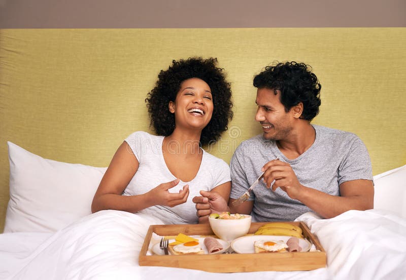 Breakfast in Bed. a Cute Couple Sharing Breakfast in Bed. Stock Photo ...
