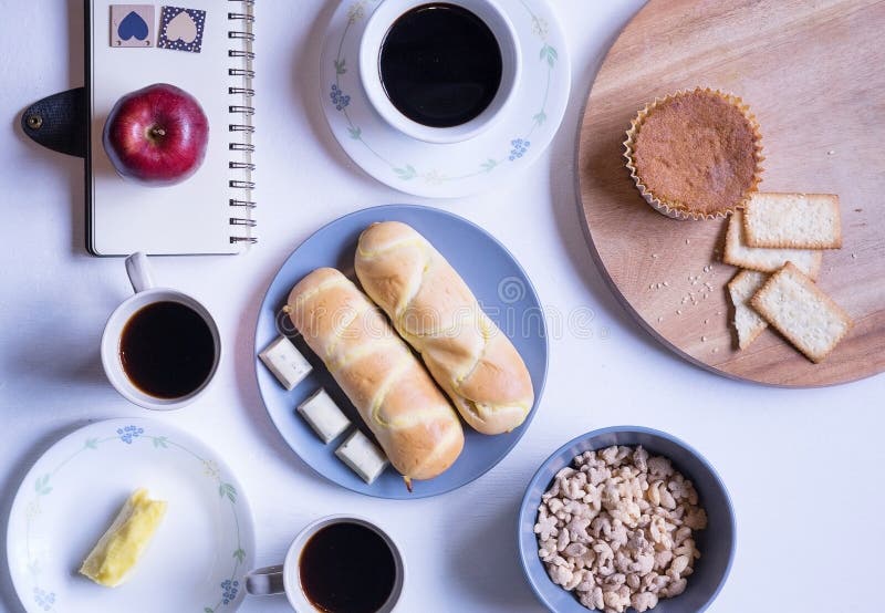 Assorted Food and Coffee with Notebook on the Table. Stock Image ...