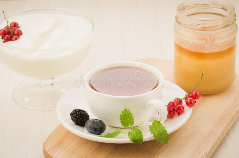 Breakfast with Cup of Tea in Berry Saucer, Jar of Honey and Yogurt ...