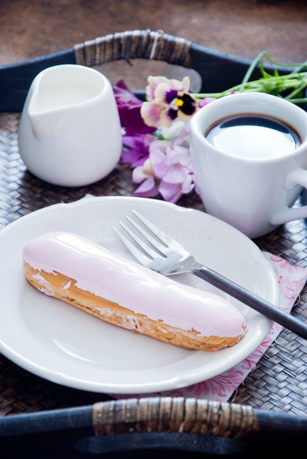 Breakfast - Eclair and Coffee Cup with Book and Flowers Stock Image ...