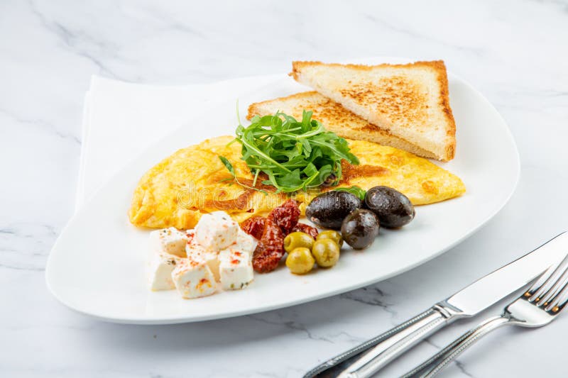 Breakfast of Eggs with Meat, Herbs and Drops of Sauce with Bread in a ...