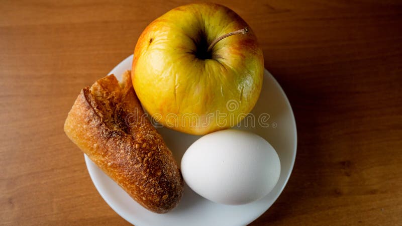 Breakfast Essentials Featuring an Egg, Apple, and Fresh Bread Roll ...