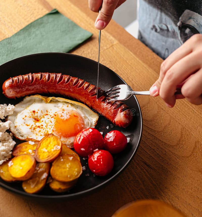 Breakfast Plate with a Woman Cutting the Sausage Stock Photo - Image of ...