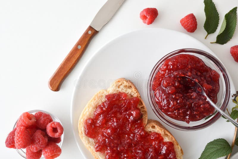 Breakfast with Raspberry Jam on White Table Top View Stock Photo ...