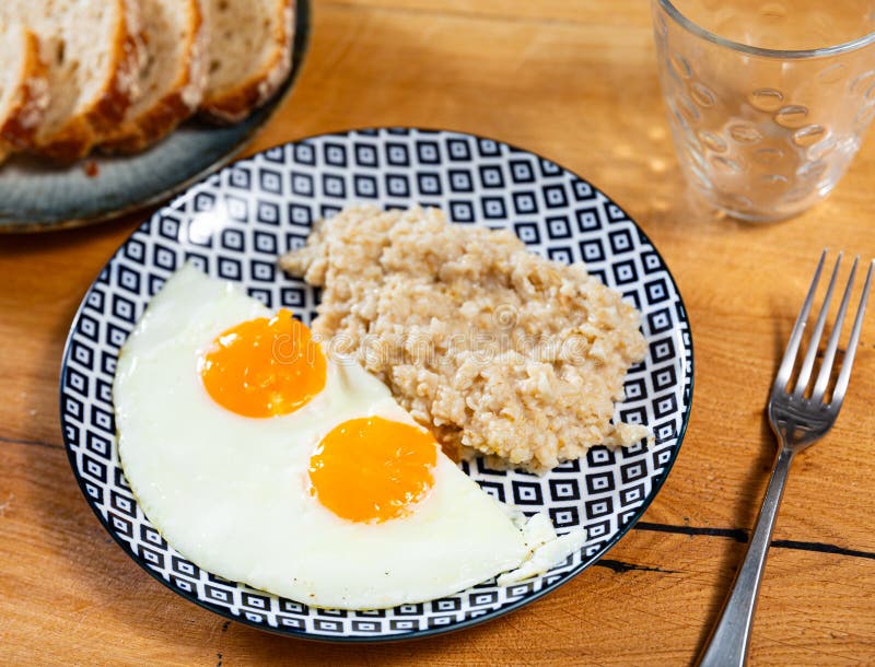 Breakfast with Scrambled Eggs and Oatmeal with Butter Closeup Stock ...