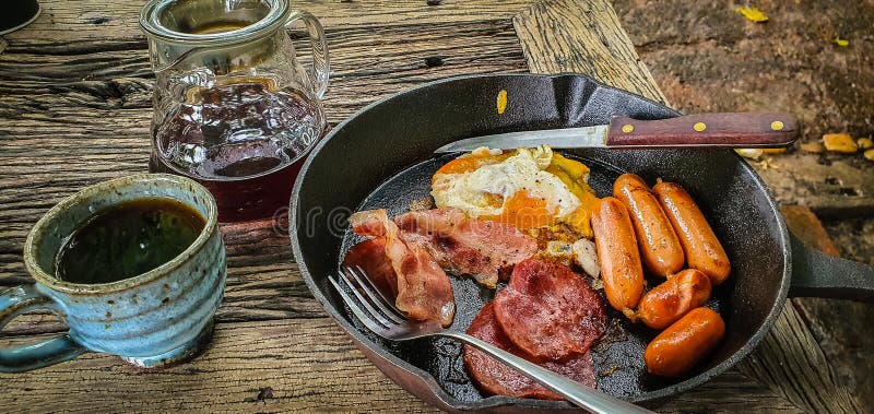 Breakfast Set: Bacon, Ham, Sausages and Fried Eggs in a Cast Iron ...
