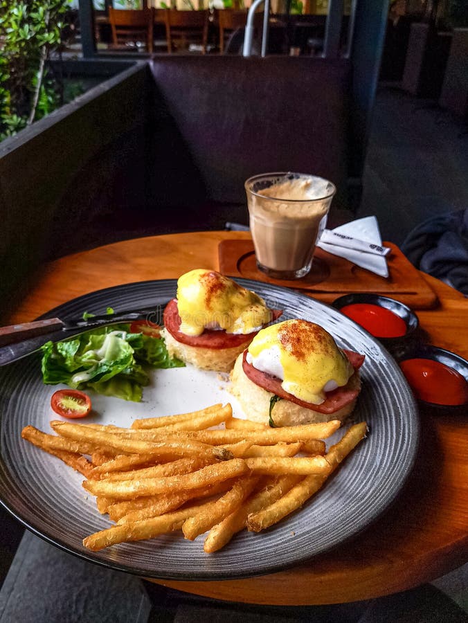 Breakfast Set Featuring Eggs Benedict, Crispy Fries, Fresh Salad, and ...