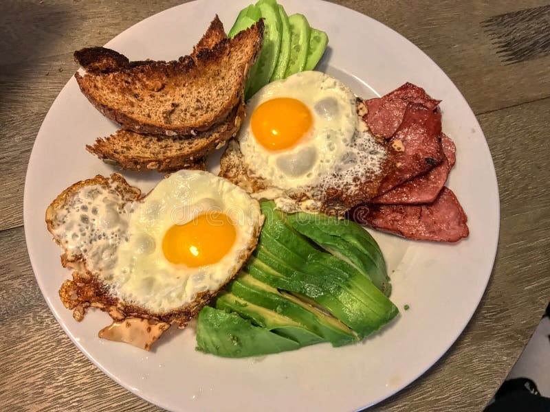 Breakfast Set. Fried Eggs with Bread, Bacon, Fresh Cucumber and Avocado ...