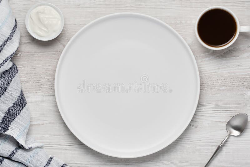 Breakfast Setup with an Empty Plate, Coffee Cup, and Sour Cream on a ...