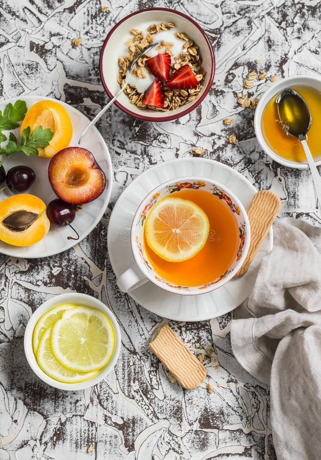 Breakfast or Snack Table. Lemon Tea, Fresh Fruit, Yogurt with Granola ...