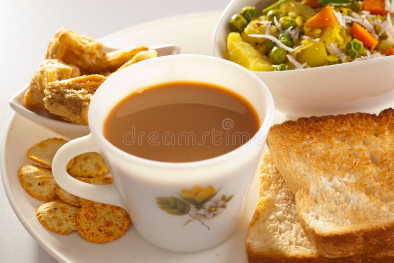 Breakfast - Tea, Poha with Bread and Biscuit. Stock Photo - Image of ...