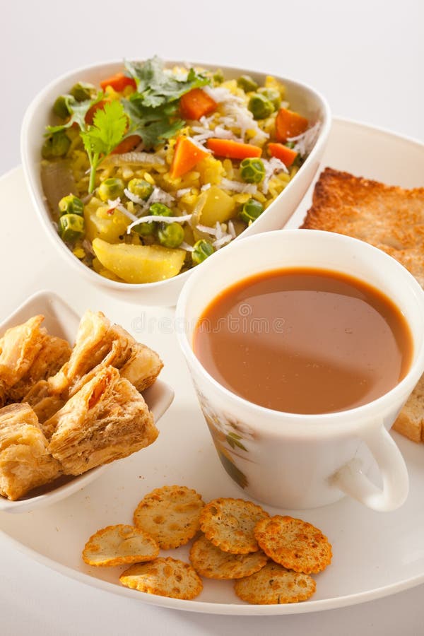 Breakfast - Tea, Poha with Bread and Biscuit. Stock Photo - Image of ...