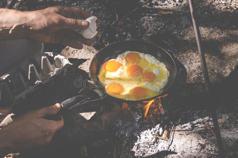 Egg Cooked by Men`s Hands on a Fire in the Woods Stock Image - Image of ...