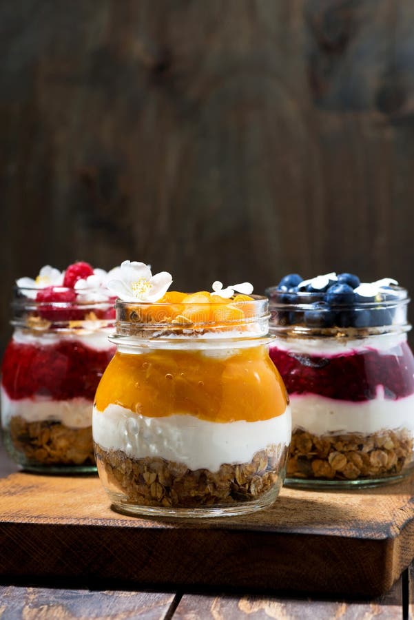 Breakfasts in Jars with Muesli, Berry Puree and Cream, Vertical Stock ...