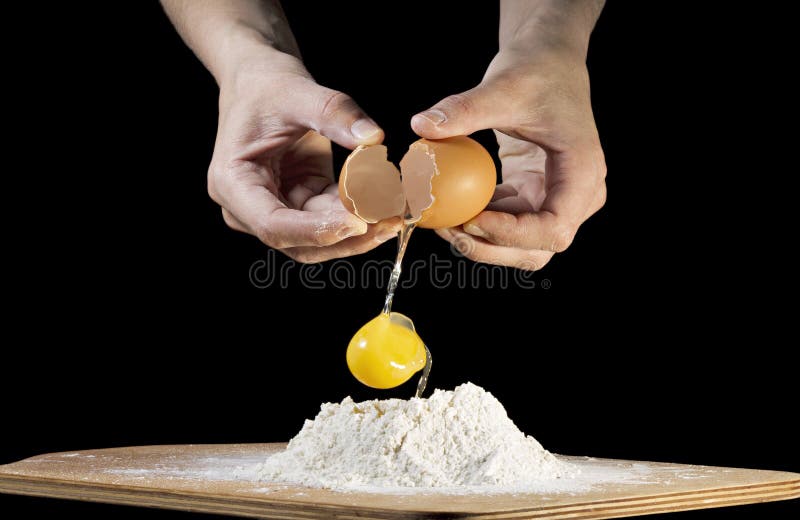 Breaking Eggs into Flour Isolated Stock Image - Image of closeup, black ...
