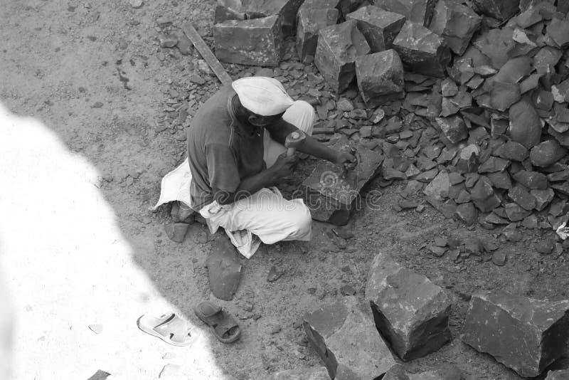 Man breaking rocks stock photo. Image of craftsman, hammer - 2581092
