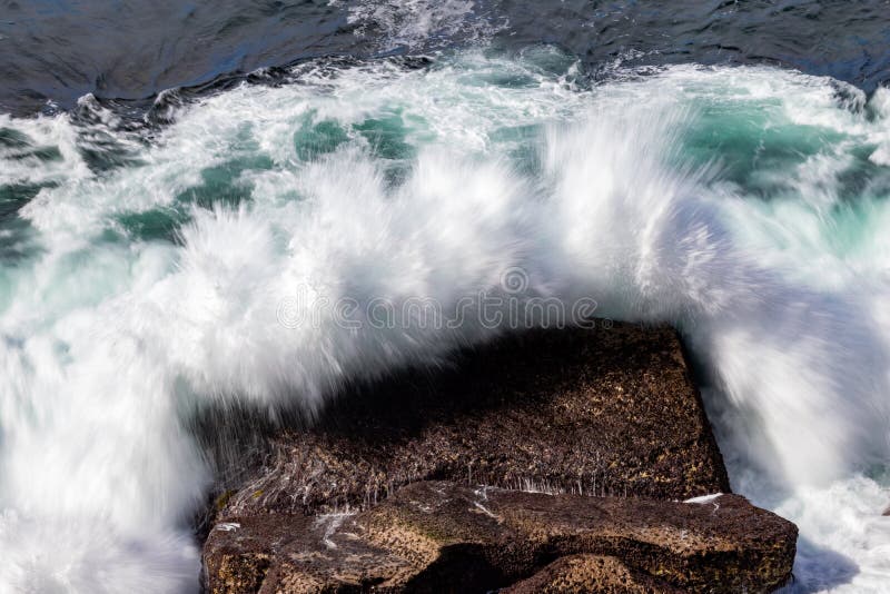 Breaking wave on rock stock photo. Image of water, rock - 215556806