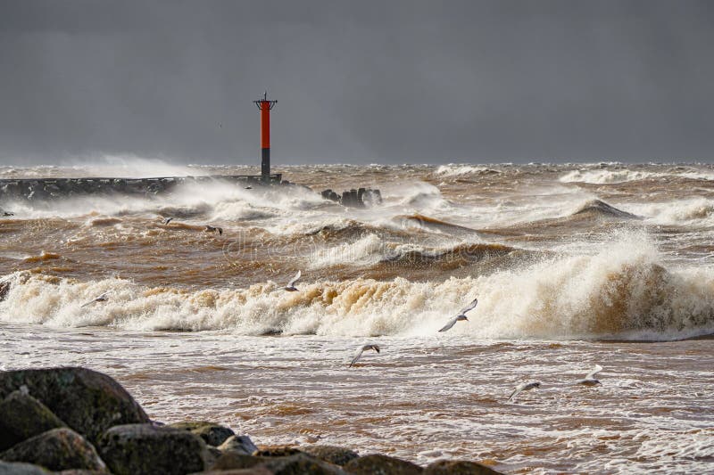 Breakwater with a Lighthouse in a Storm Stock Photo - Image of white ...
