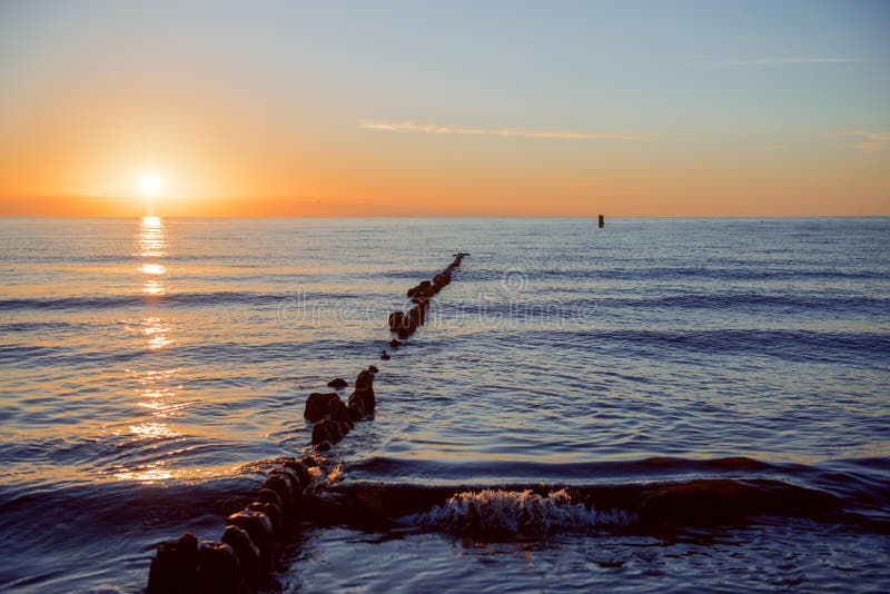 Breakwaters in the Baltic Sea Over the Sunset Stock Photo - Image of ...
