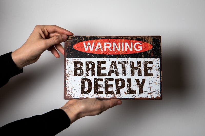 Breathe Deeply. Warning Sign with Text on a White Background in a Woman ...