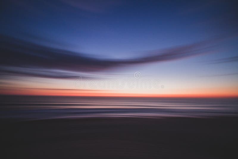 Breathtaking Shot of the Reflection of a Colorful Sunset with Long ...