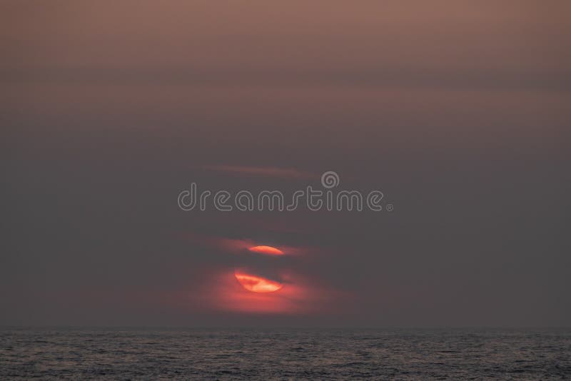 Breathtaking Sunset Over the Ocean with a Clear Sky and a Bright Red ...