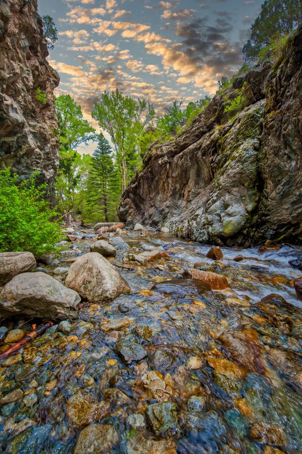 Breathtaking Sunset Sky with Light Clouds Above a Stream with Rocky ...