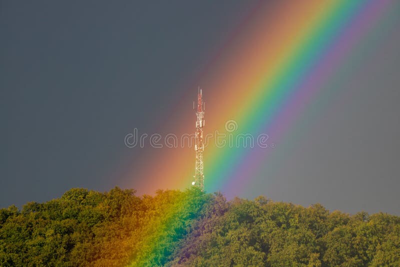 Breathtaking View of Colorful Rainbow in Gray Sky with Tower in the ...