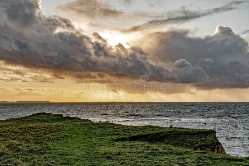 Breathtaking View of a Grass Covered Cliff Over the Ocean Under the ...