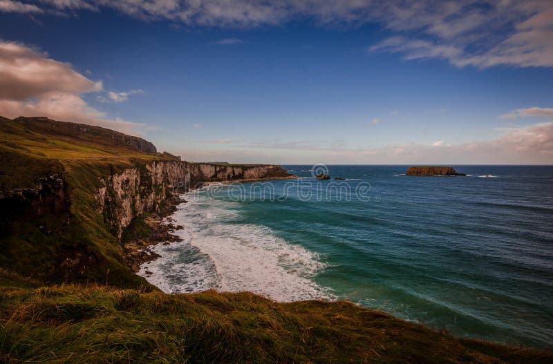 Breathtaking View of the Grass-covered Cliffs by the Ocean Under the ...