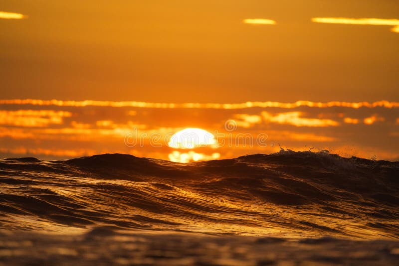 Breathtaking View of Ocean Waves with Bright Sun in Orange Sunset Sky ...
