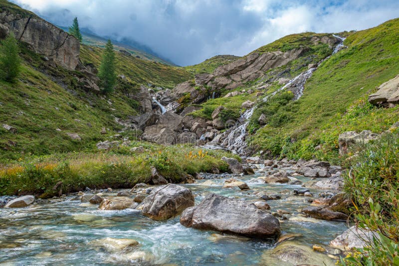 A River Streaming in a Middle of a Green Landscape in the Tour Du Mount ...