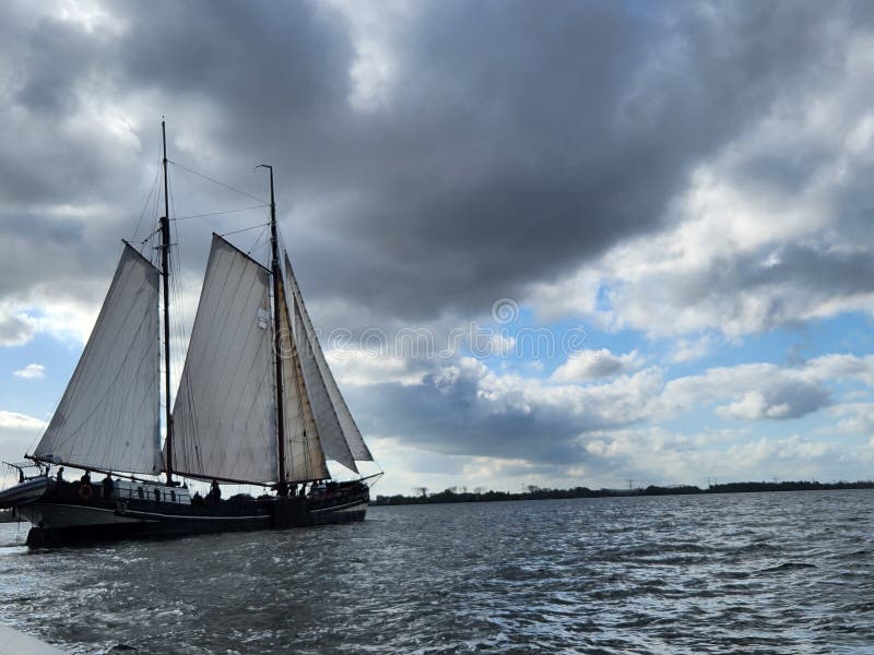 Traditional Sailing Ship on Open Water Under Dramatic Skies Stock Image ...