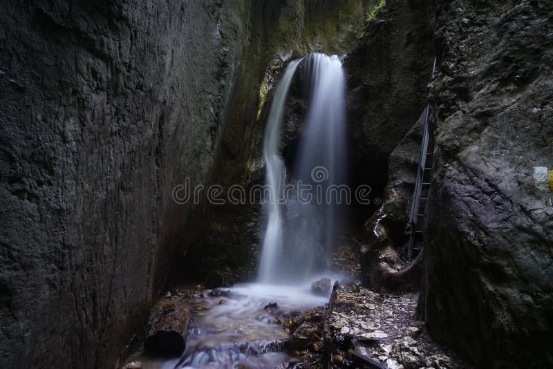 Breathtaking View of a Waterfall between Rocks in Gorge with Narrow ...