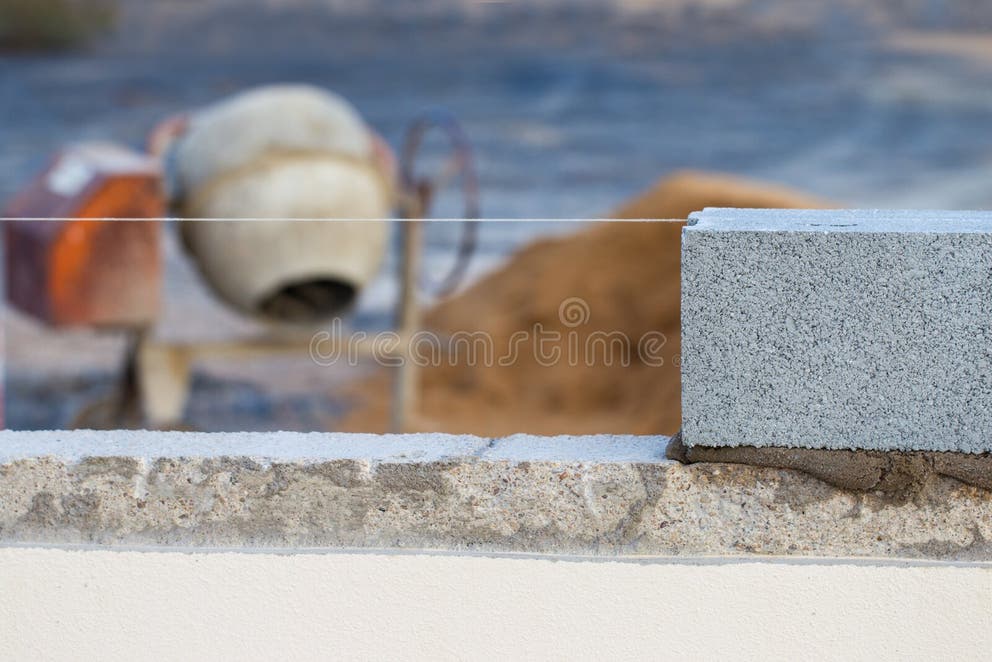 Breeze Block Wall Construction with String Line and Cement Mixer Stock ...