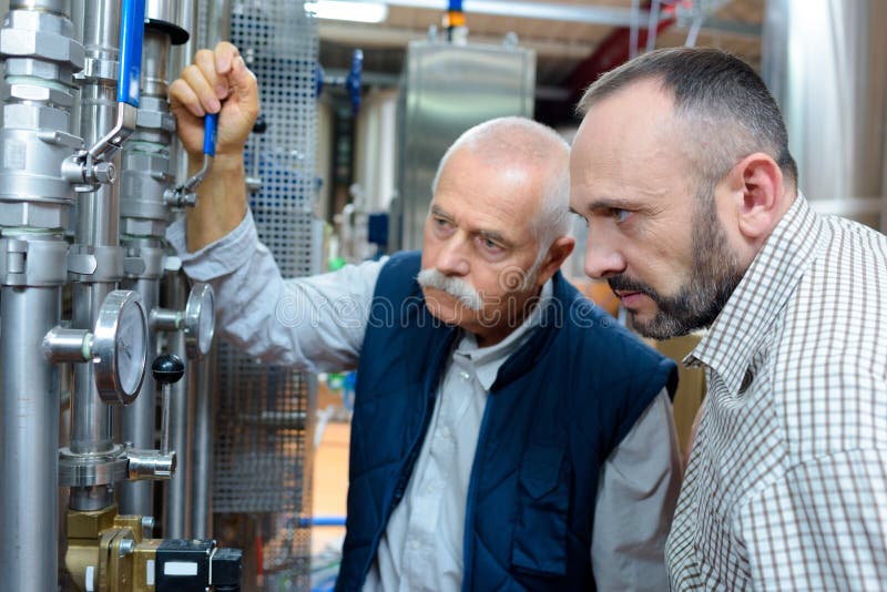 Brewery Boss and Worker Inspecting Pressure Stock Photo - Image of ...